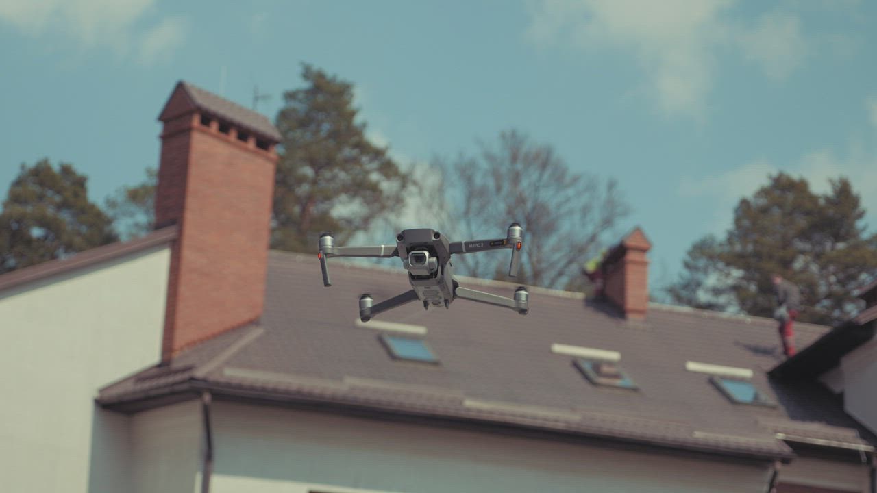 Drone hovering in front of a house - Free Stock Video