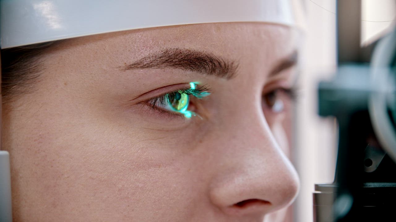 Eyes of a woman being checked by a vision device - Free Stock Video