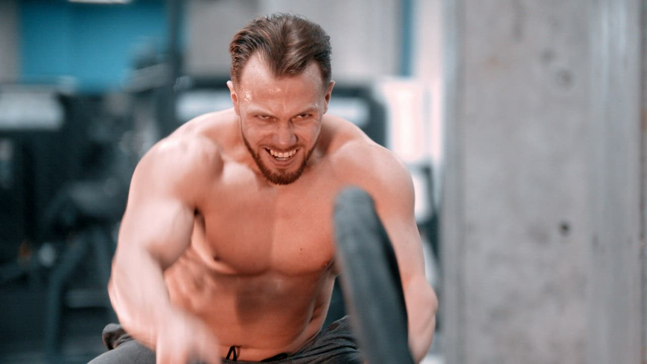 Bodybuilder training hard with ropes at the gym - Free Stock Video