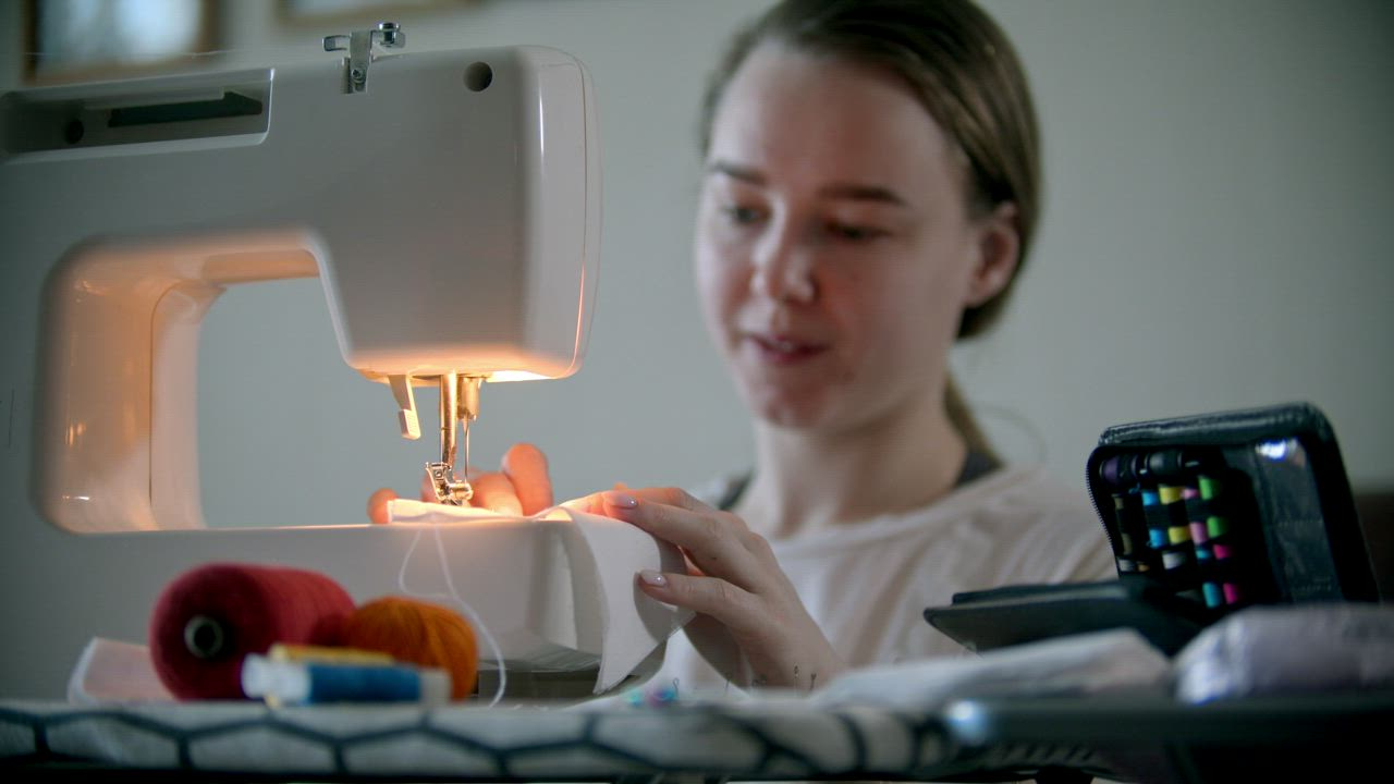 Young woman working on a sewing machine - Free Stock Video