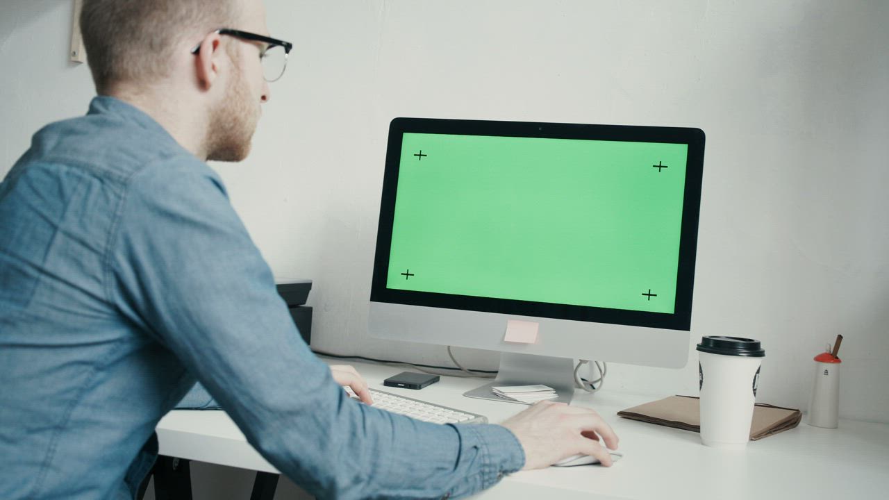 Man working on green screen monitor in minimal office - Free Stock Video