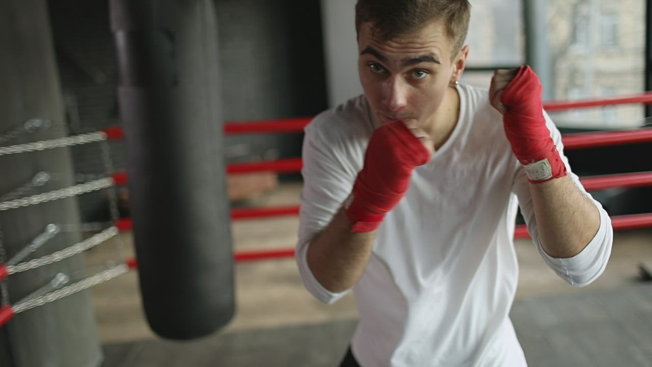 Man shows off boxing moves with red handwraps - Free Stock Video