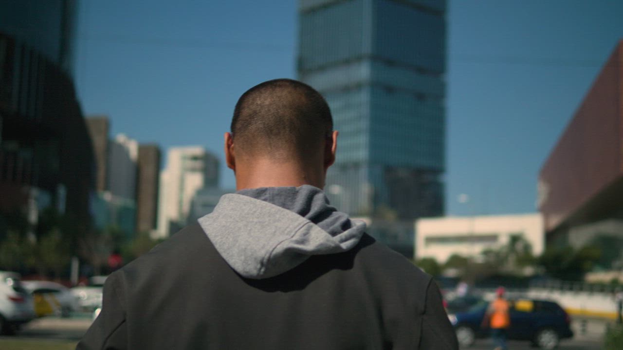 A man being followed walking in a city - Free Stock Video