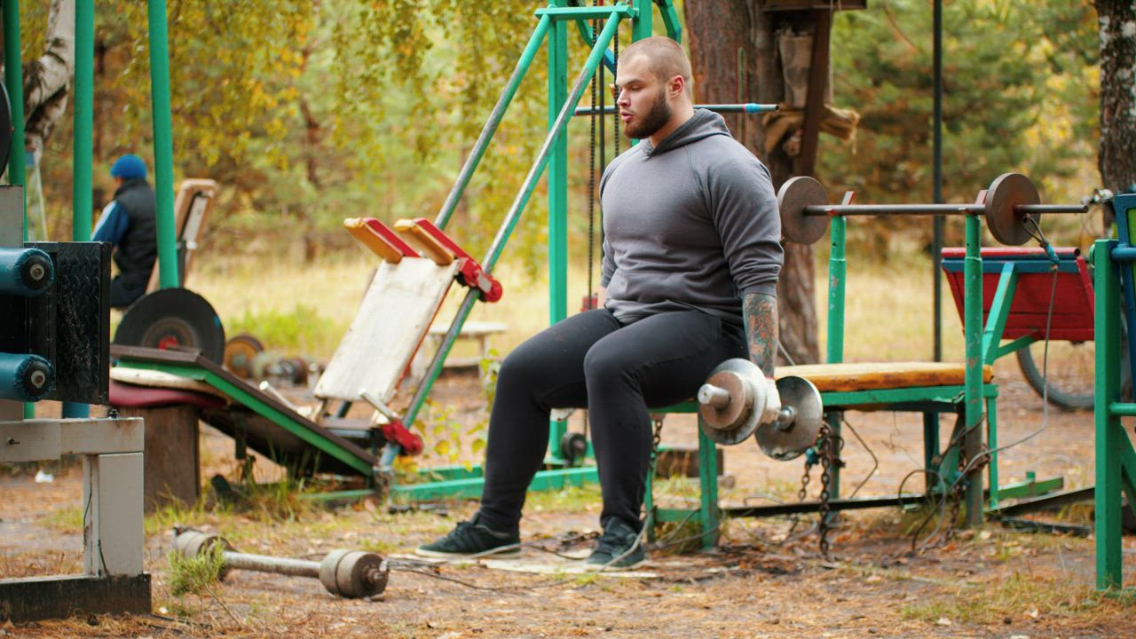 Body builder training in an outdoor gym - Free Stock Video