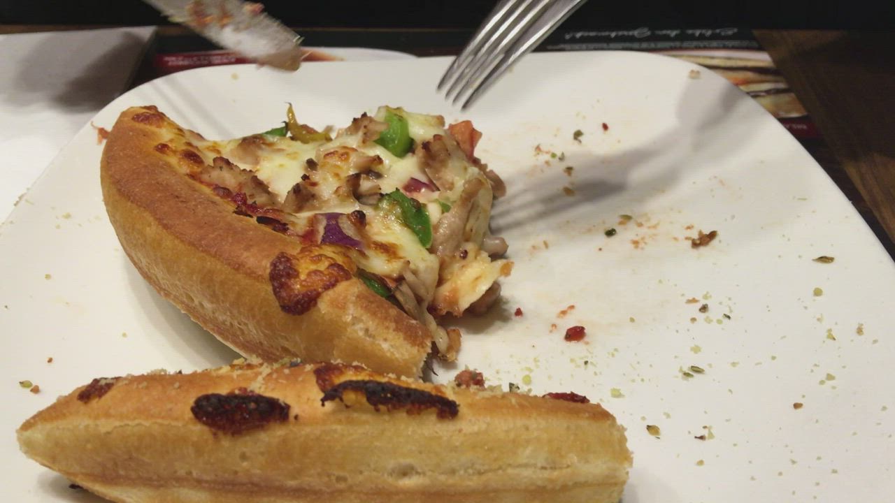 Person eating pizza using cutlery - Free Stock Video