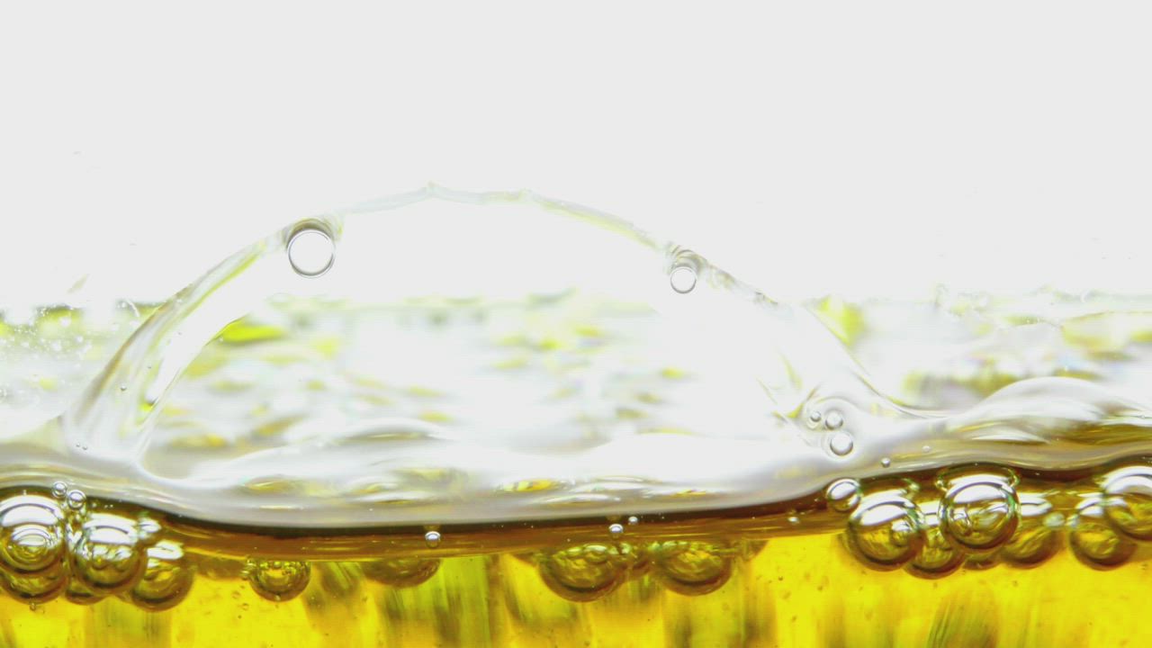 Bubbles in oil on white background - Free Stock Video