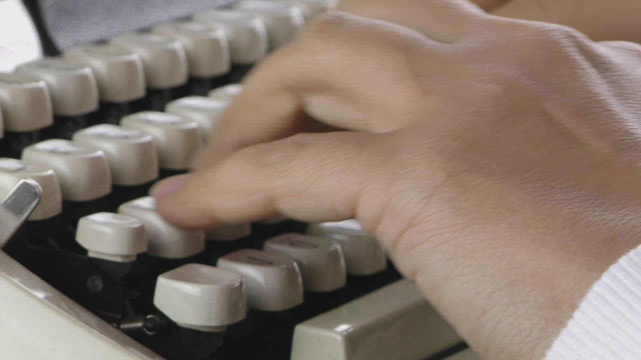 Person typing on old typewriter - Free Stock Video