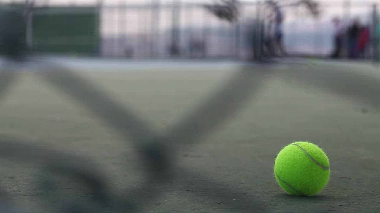 Tennis ball on the ground of a court - Free Stock Video