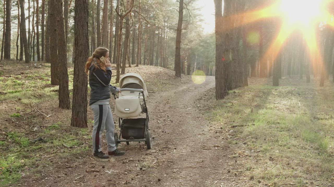Mother talking on the phone at woods - Free Stock Video