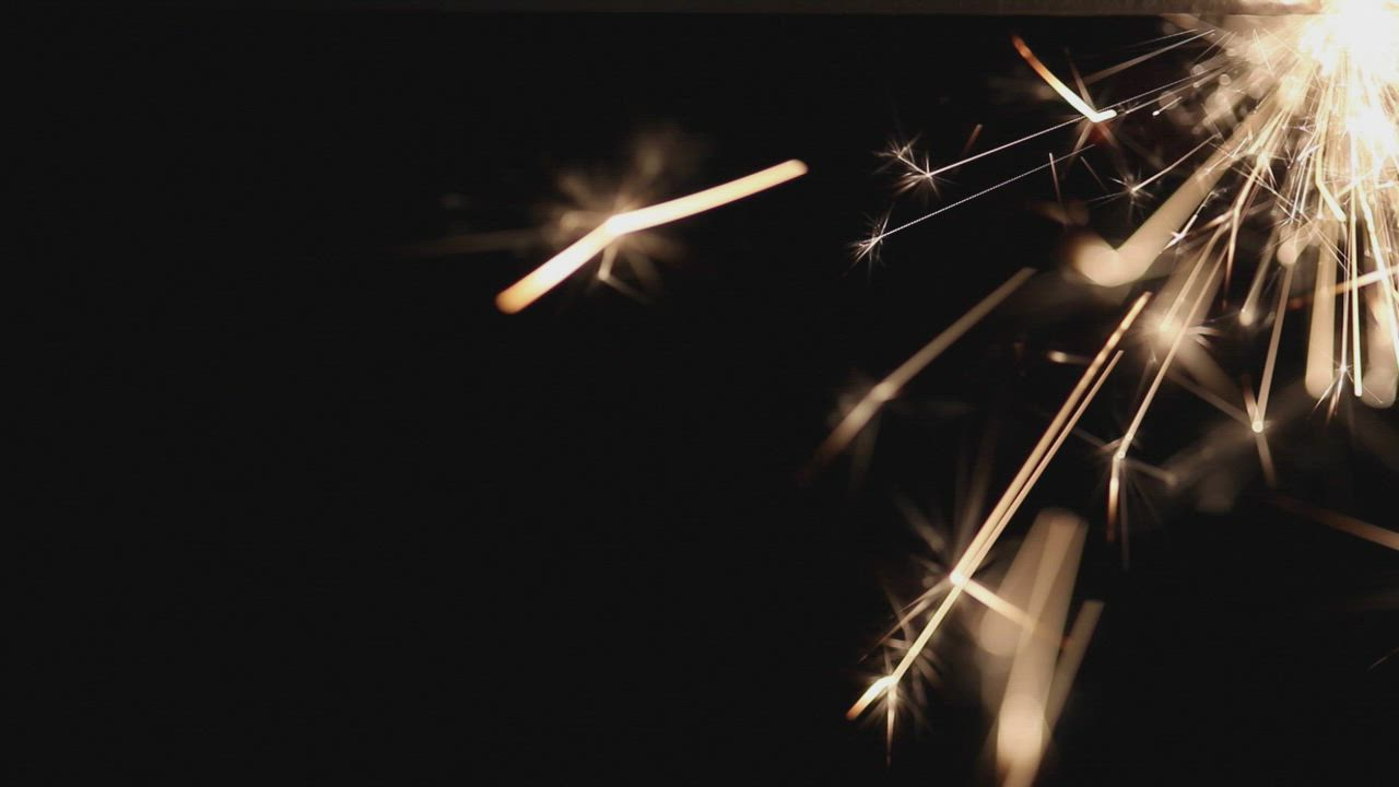 Pyrotechnic sparkler on a dark background - Free Stock Video