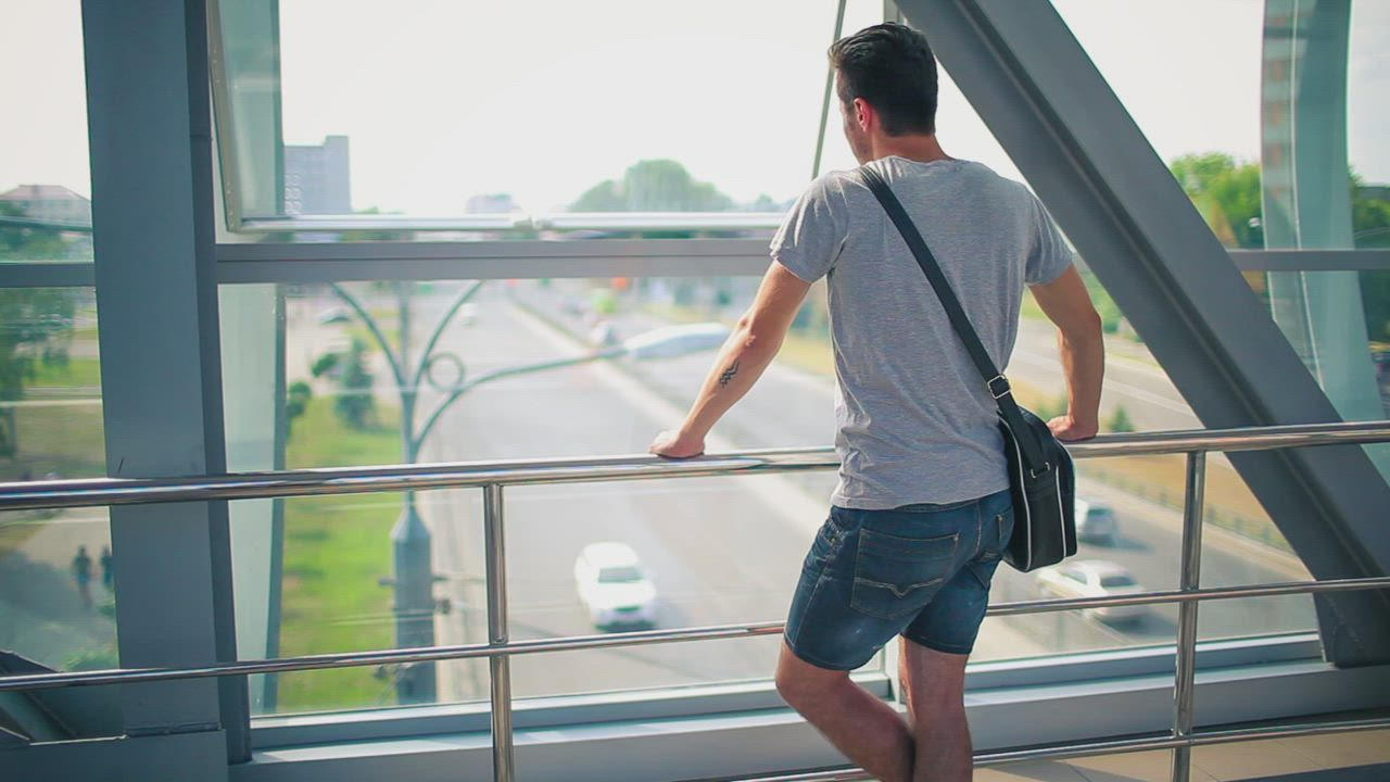 Man looking from a pedestrian bridge - Free Stock Video