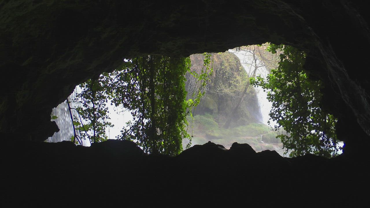 View of a waterfall from a cave - Free Stock Video