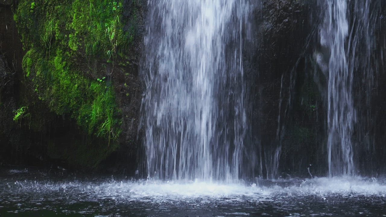 Rocky waterfall falling into the lake - Free Stock Video