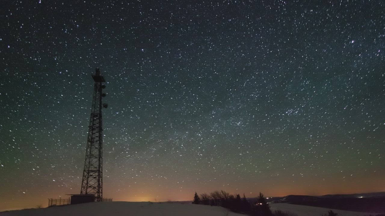 Stars over a communications tower - Free Stock Video