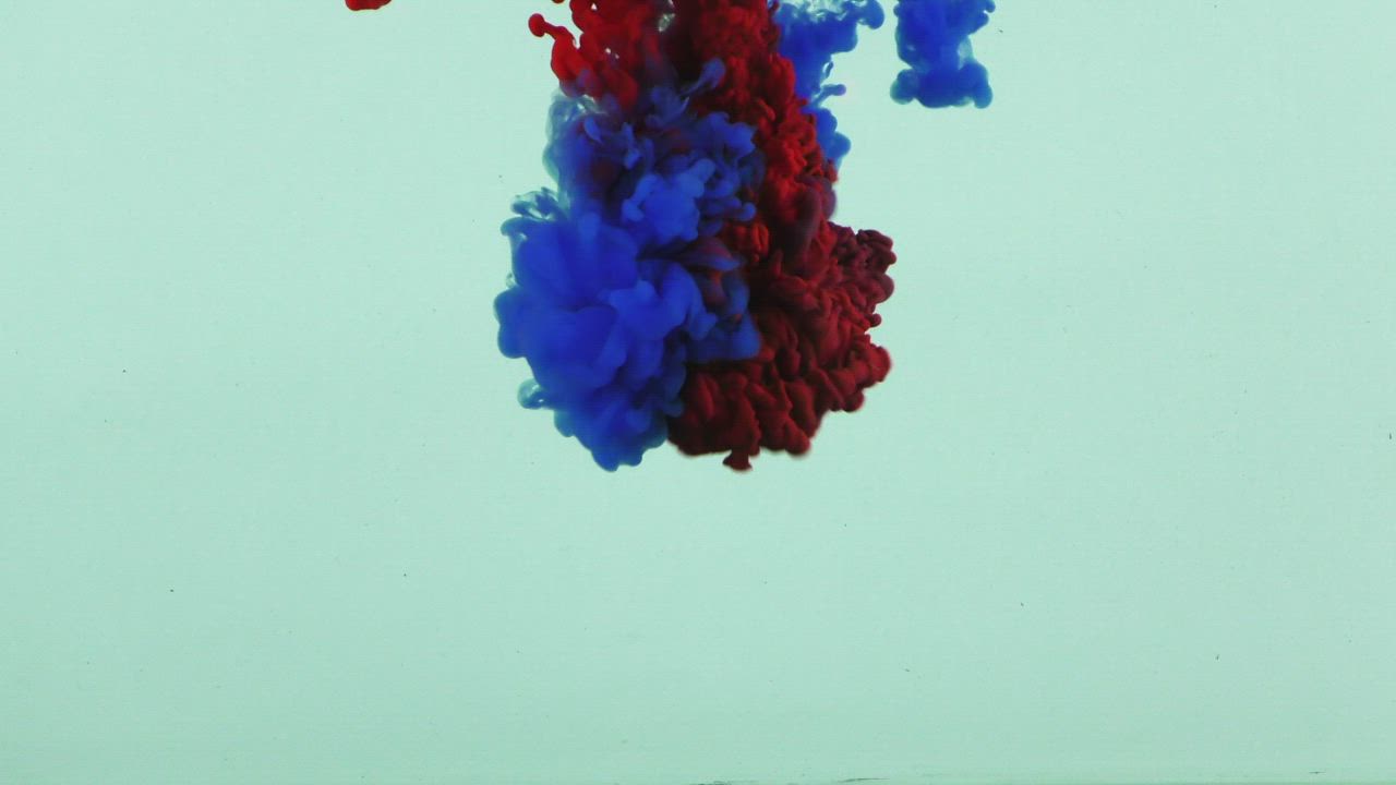 Clouds of red and blue ink underwater - Free Stock Video
