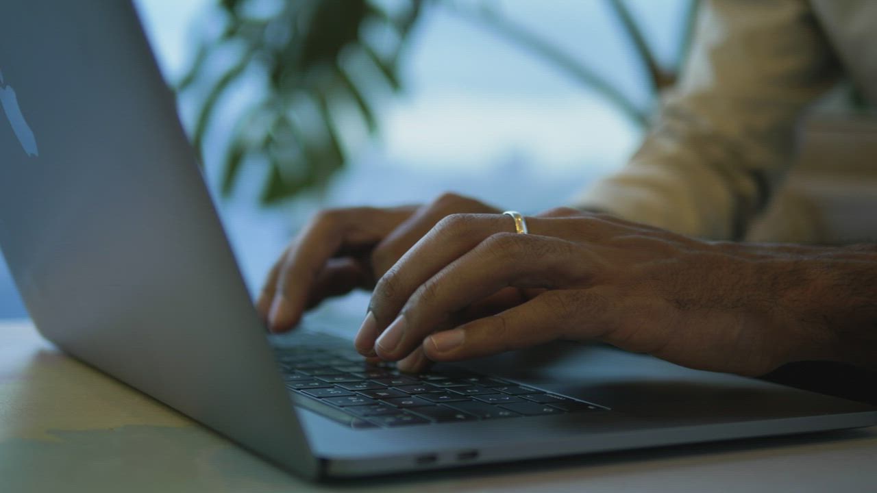 Hands typing away on a laptop - Free Stock Video