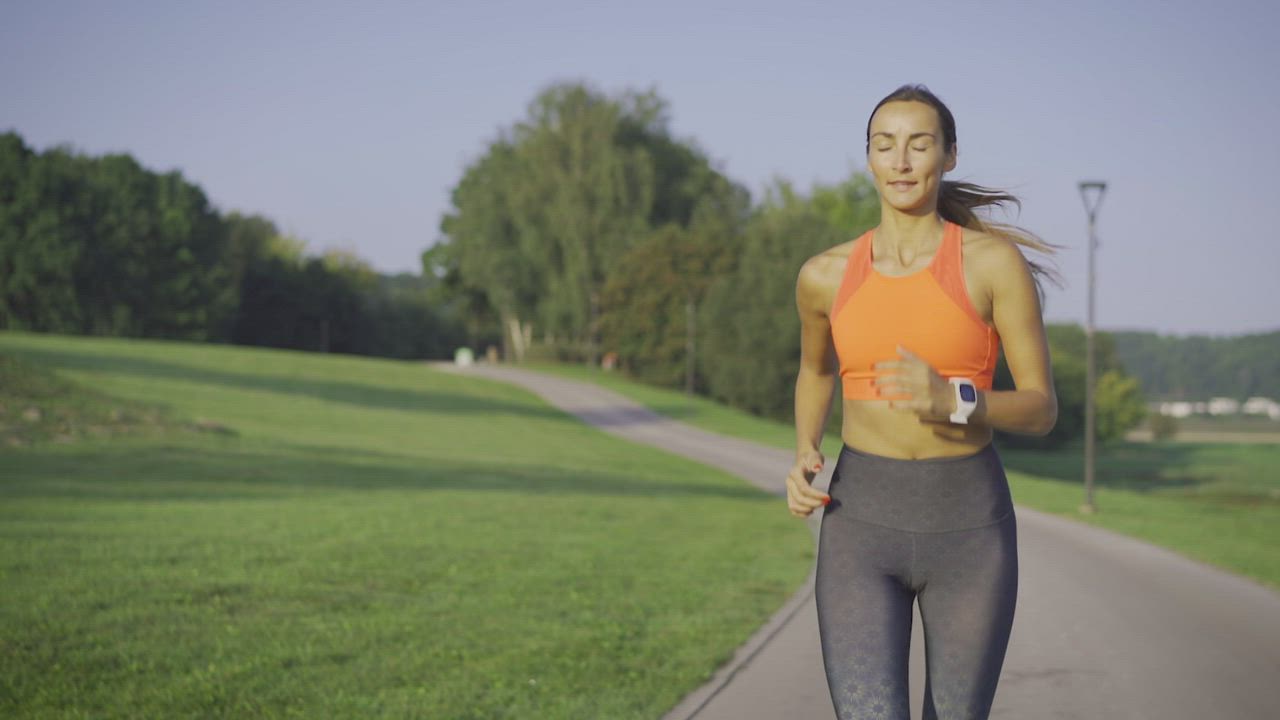 Woman running in the park - Free Stock Video