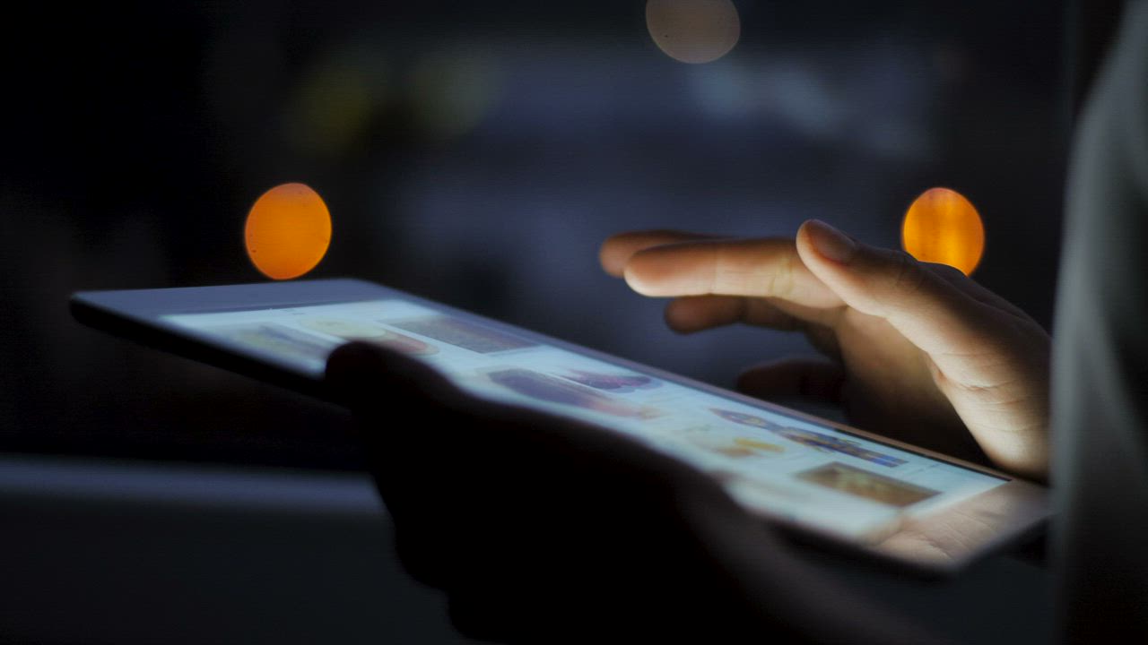 Browsing the web on a tablet at night - Free Stock Video