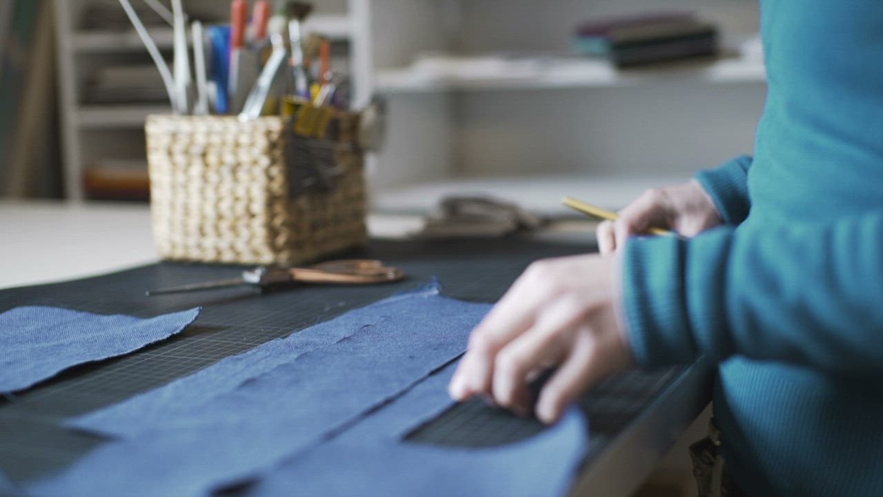 A person working with fabric - Free Stock Video