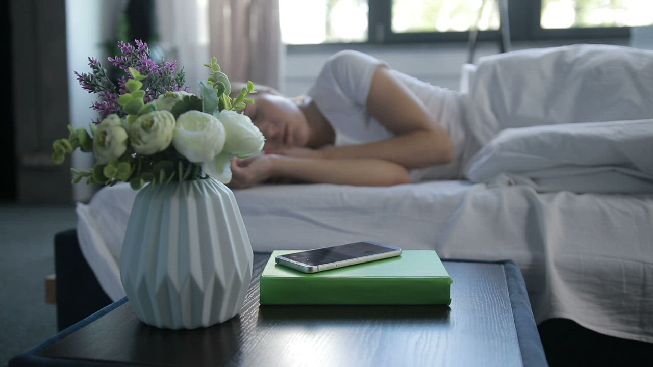 Woman switching off her alarm - Free Stock Video
