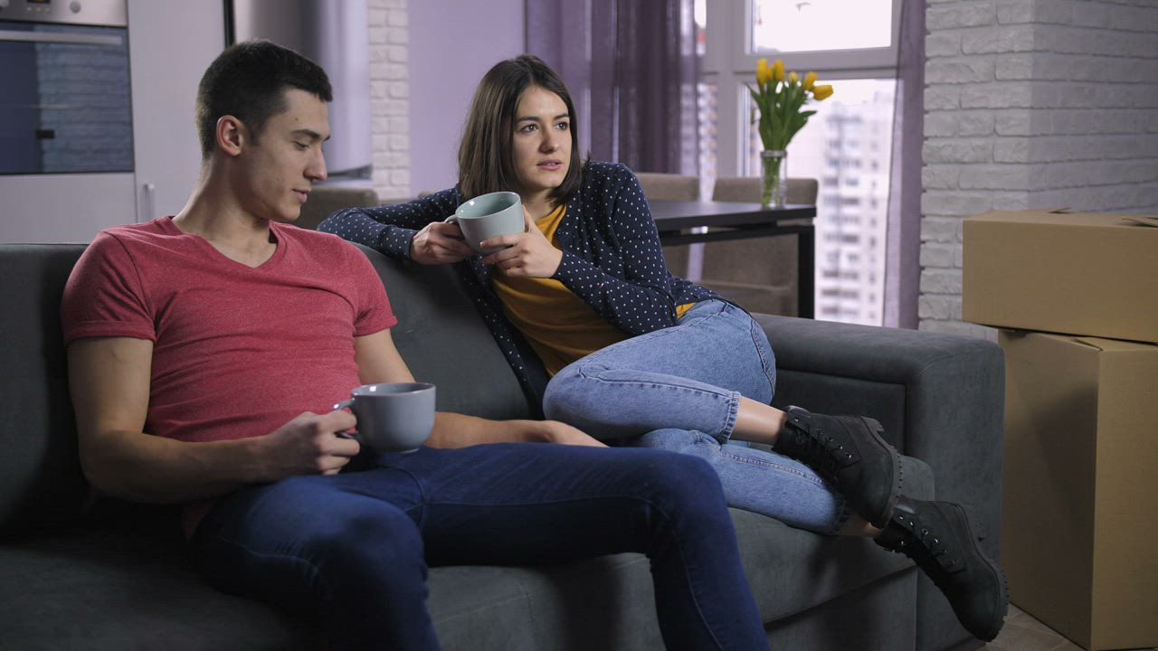 Couple drinking tea on the sofa - Free Stock Video