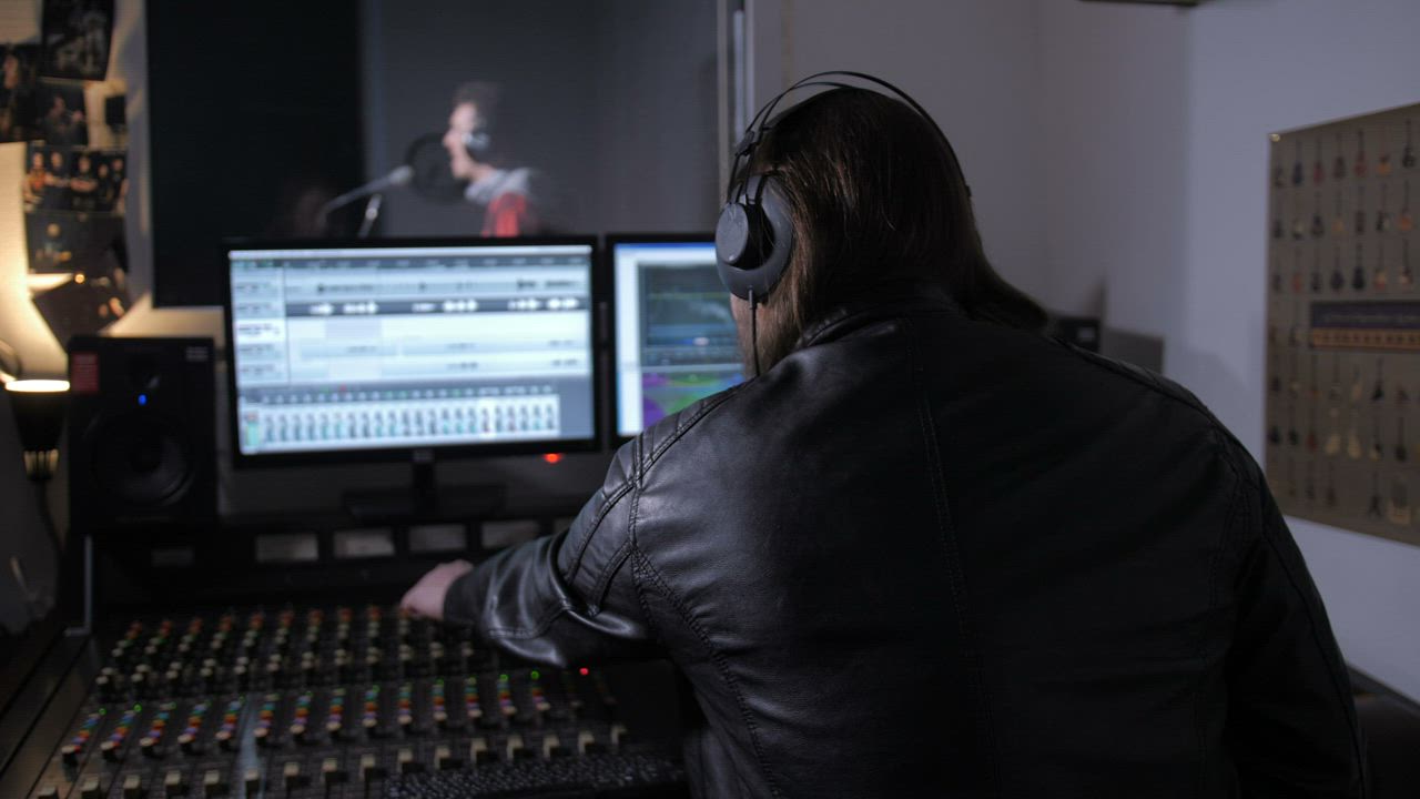 Producer working with a mixer console - Free Stock Video