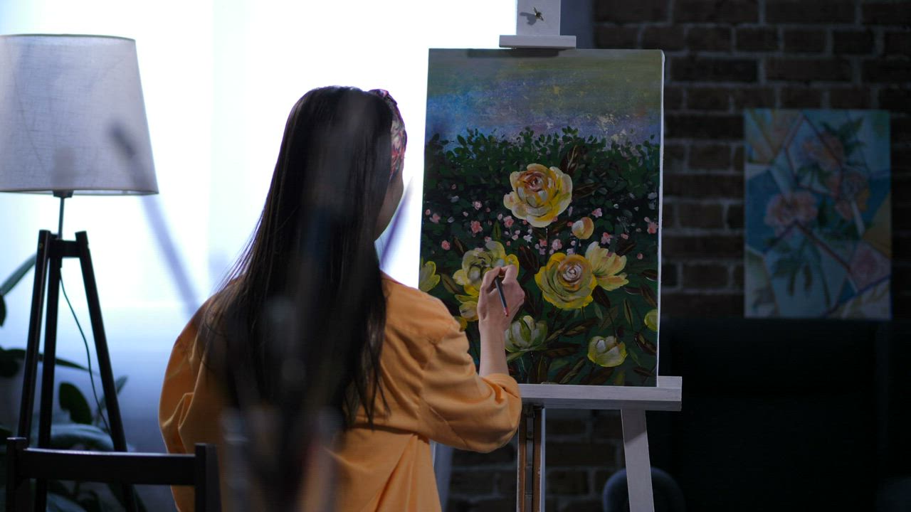 Artist adding the final details to her painting - Free Stock Video