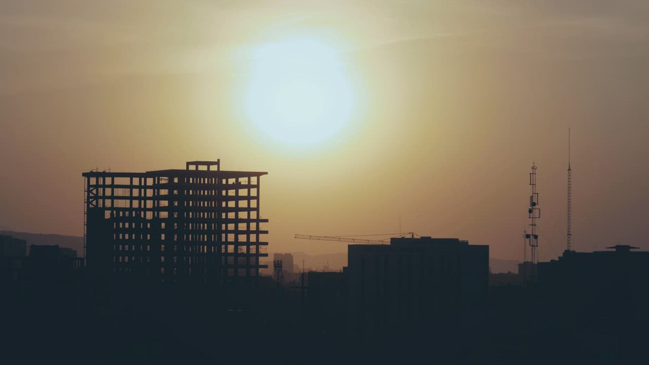 Sunset over a building under construction - Free Stock Video