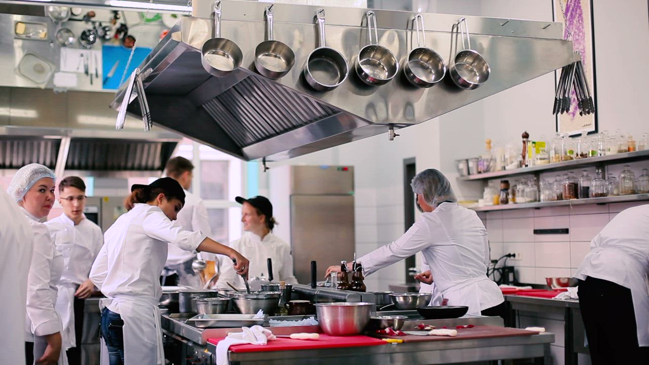 Professional chefs work in restaurant kitchen - Free Stock Video
