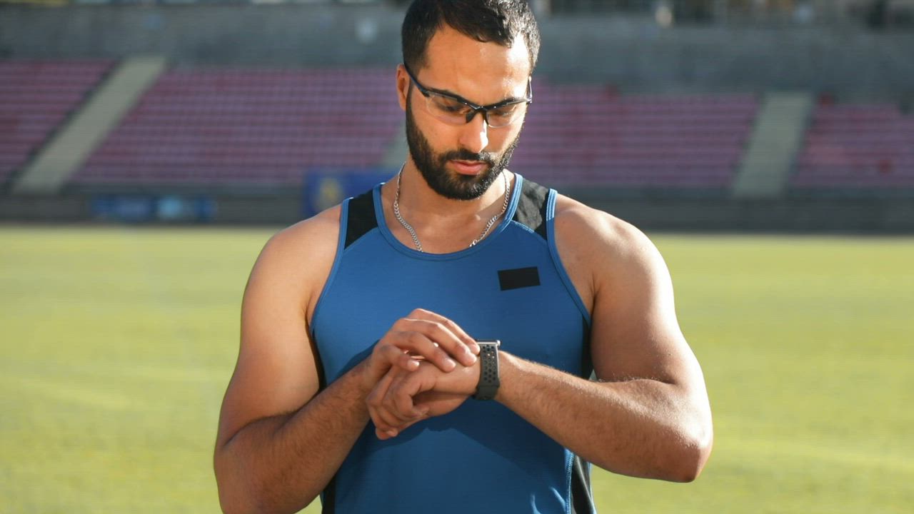 Athlete checks timer before run - Free Stock Video