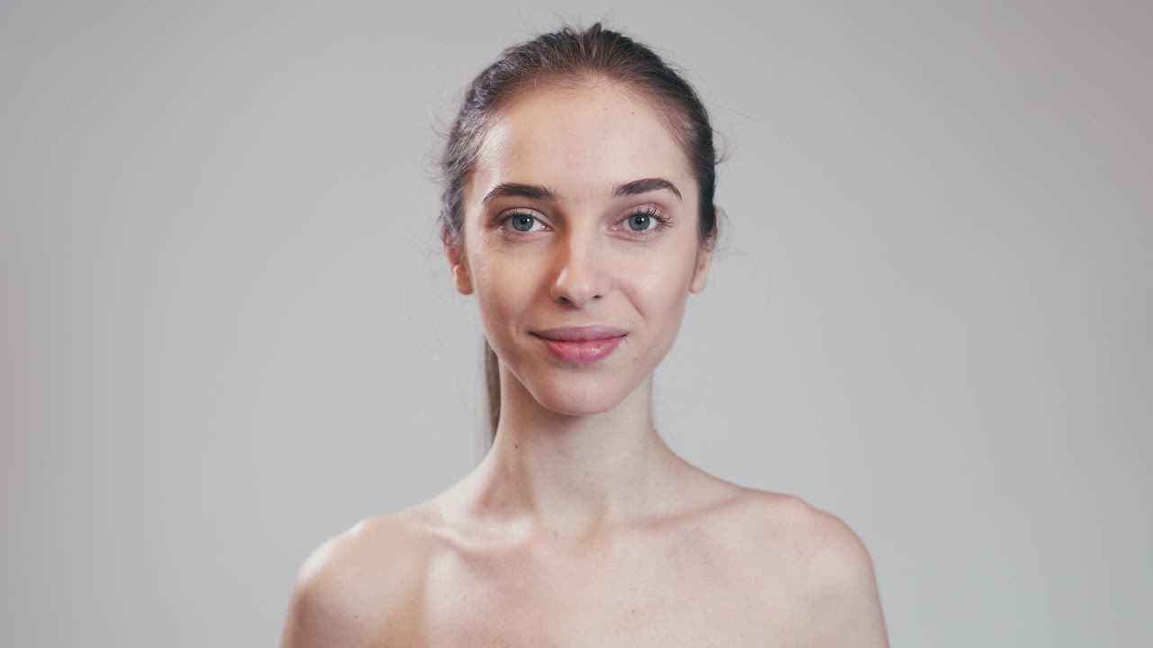 Model demonstrates acne skin care routine - Free Stock Video