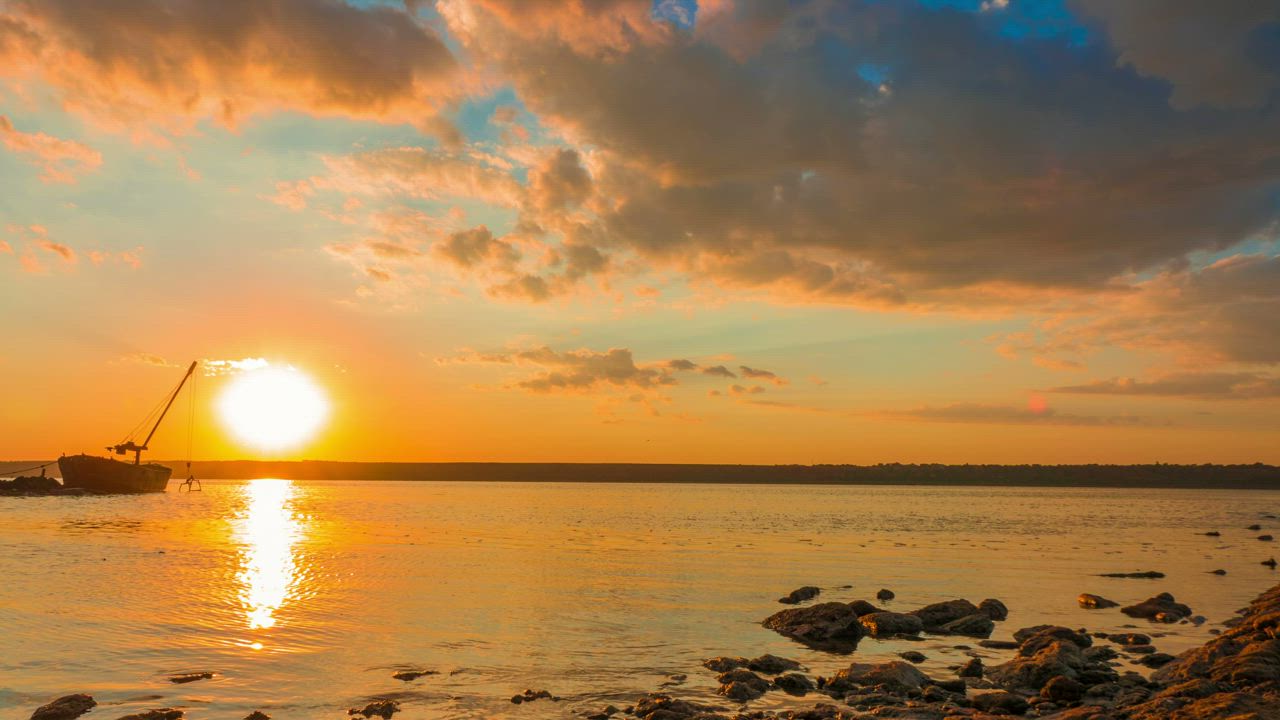 Sunset in the river with a boat - Free Stock Video