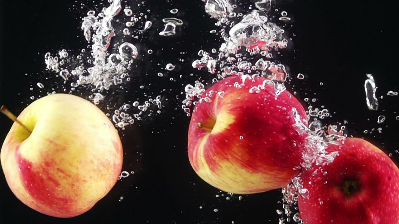 Apples falling through water - Free Stock Video