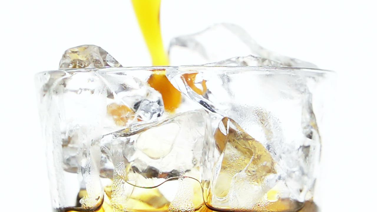 Coke falling into a glass full of ice - Free Stock Video