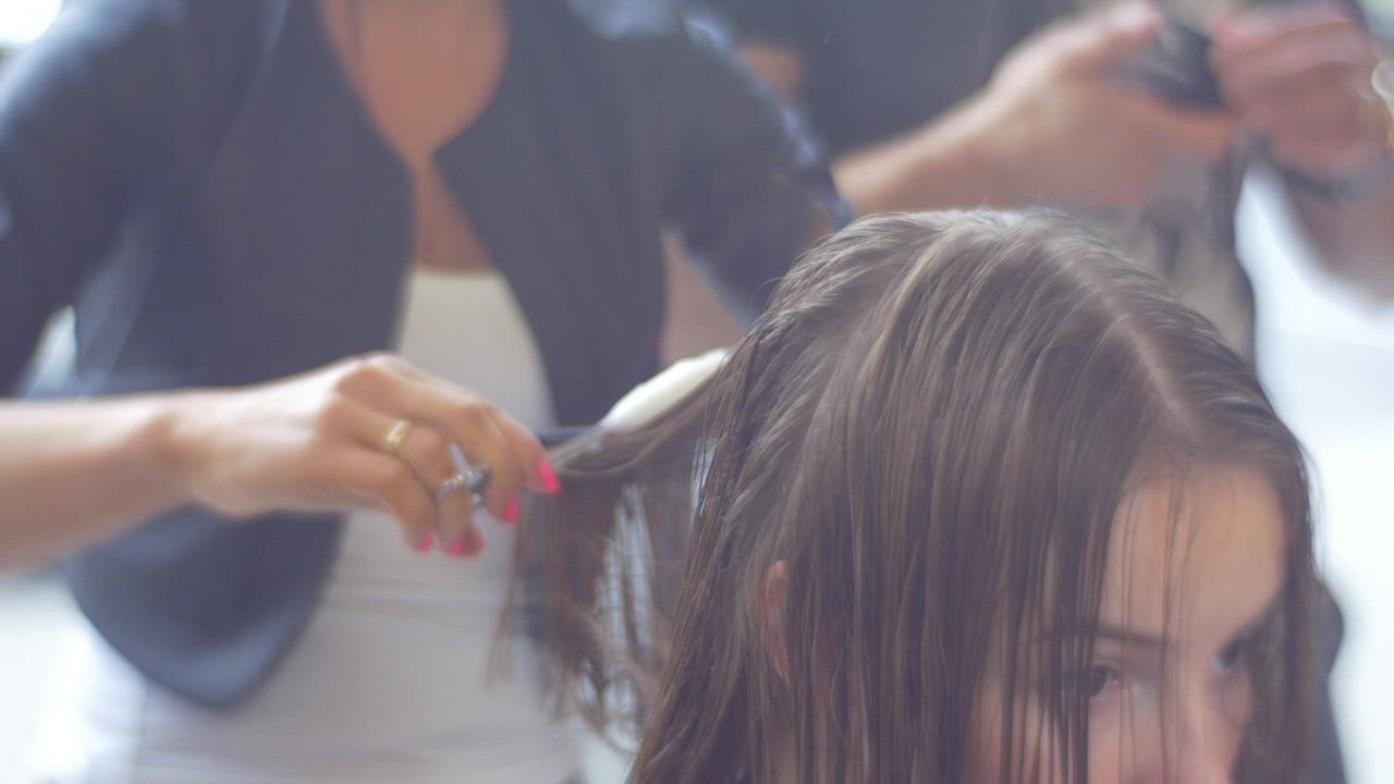 Hairdresser using fire to cut the woman's hair - Free Stock Video
