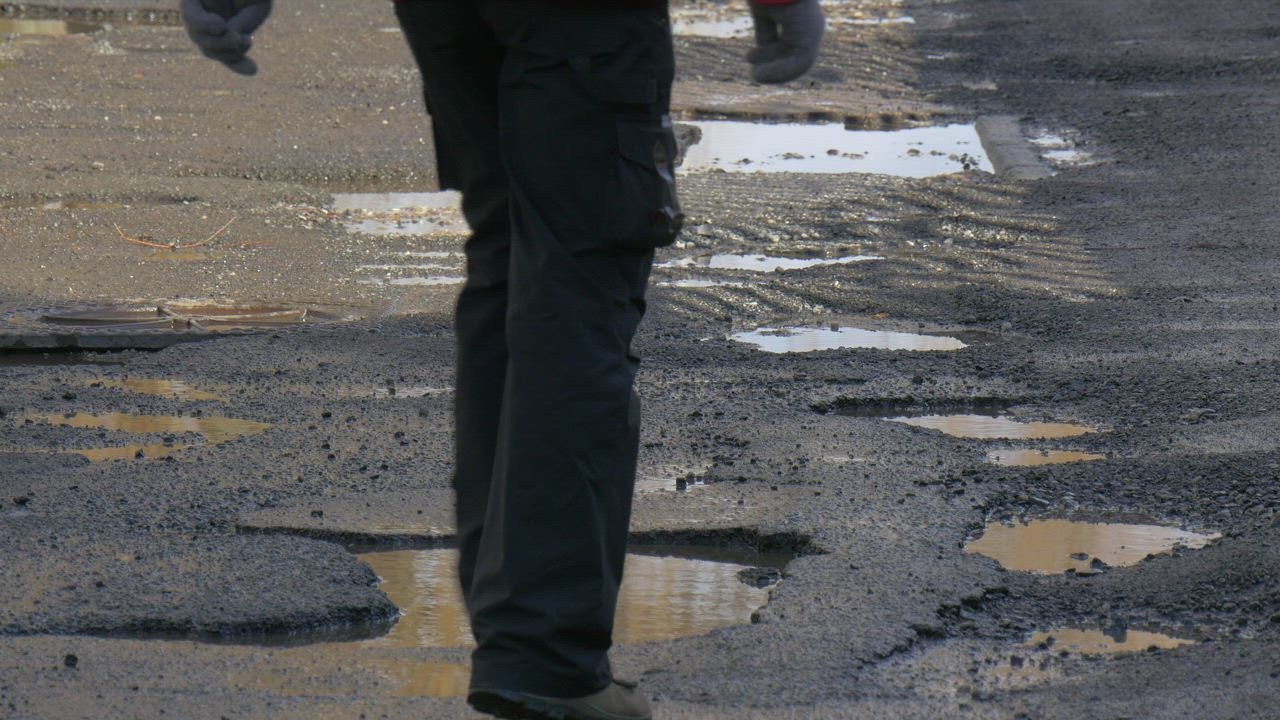 Walking on a street full of bumps - Free Stock Video