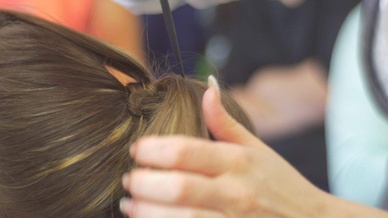 Hairstylist hands working on woman's hair - Free Stock Video