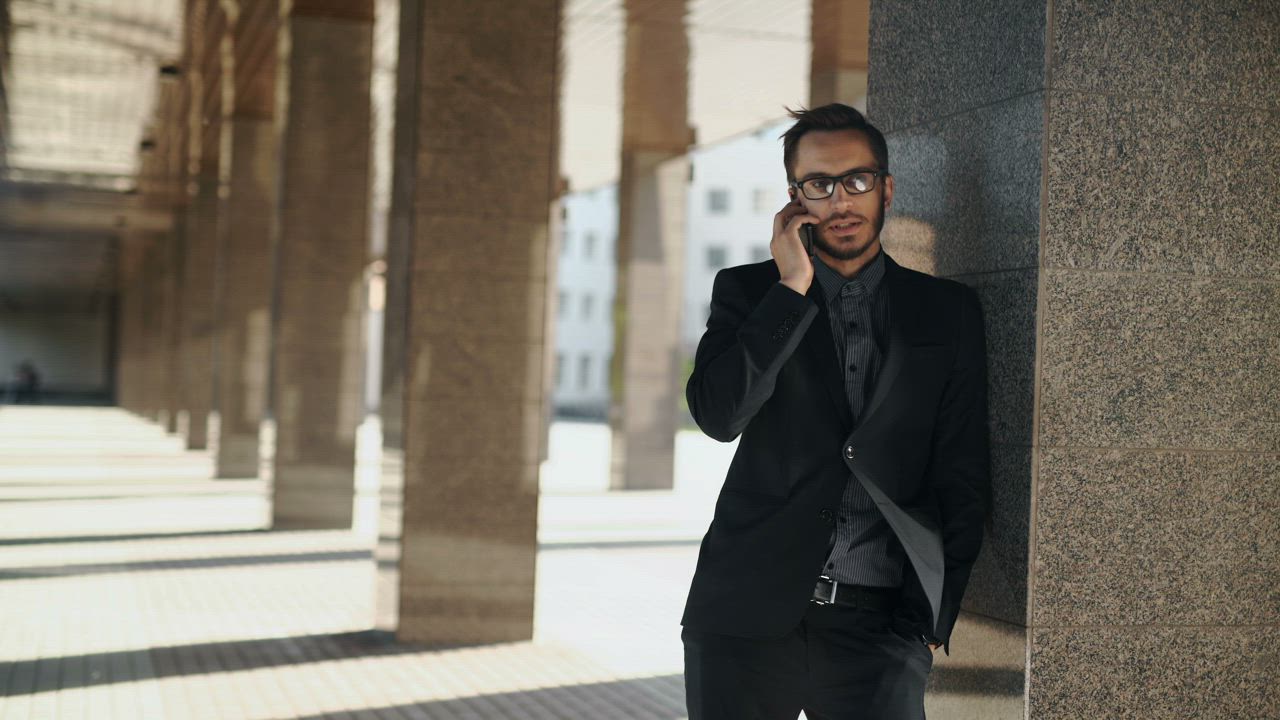 Lawyer talks on phone outside courthouse - Free Stock Video