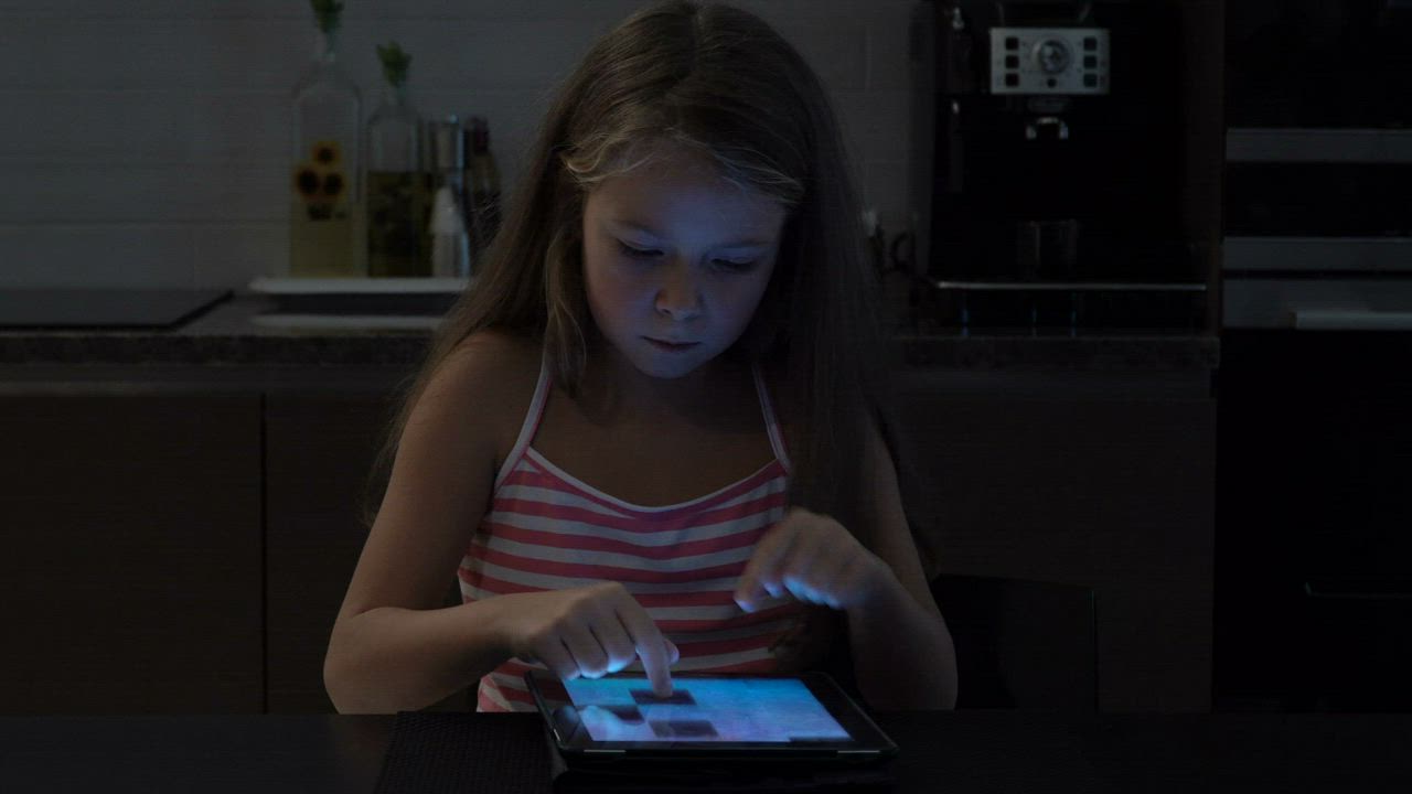 Girl playing a game on a tablet - Free Stock Video