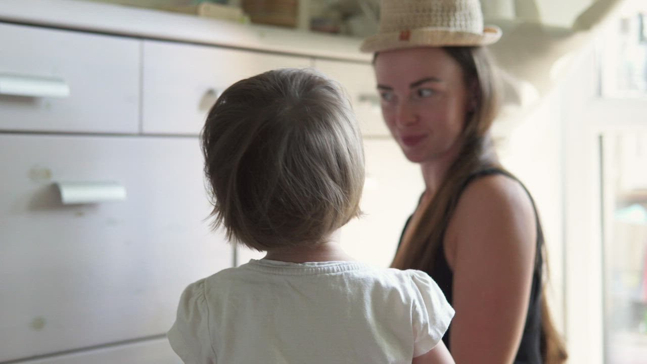 Toddler putting on a hat - Free Stock Video