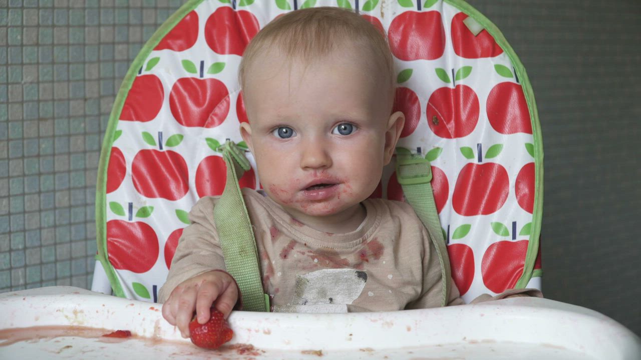 Baby having a meal and making a mess - Free Stock Video