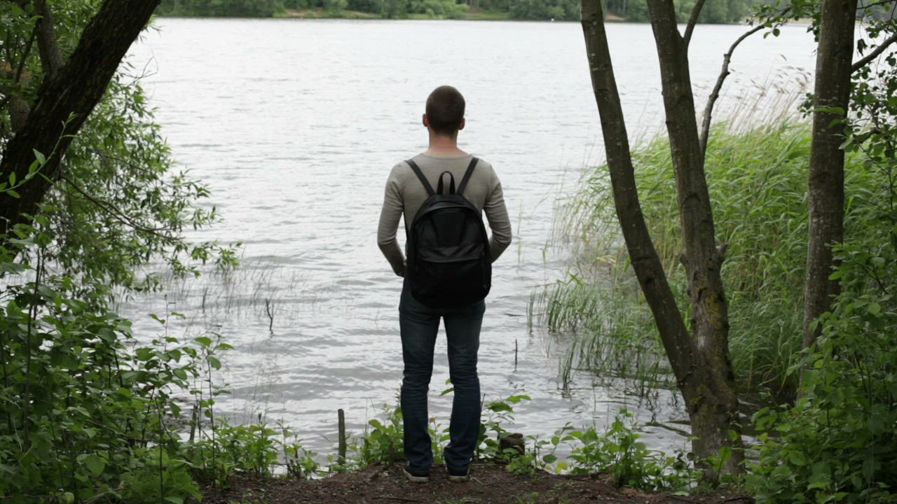 Man looking out across a lake - Free Stock Video