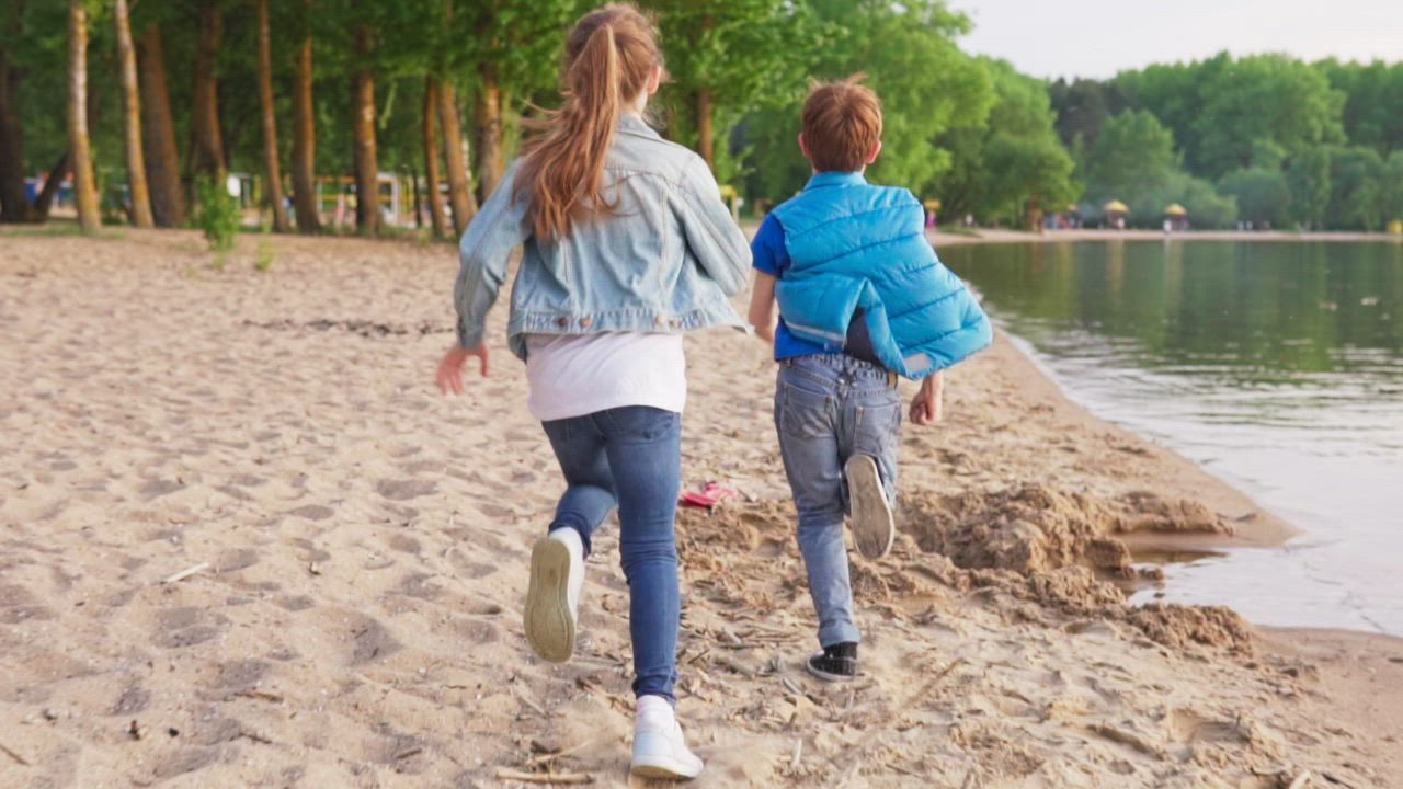Kids running by a lake - Free Stock Video
