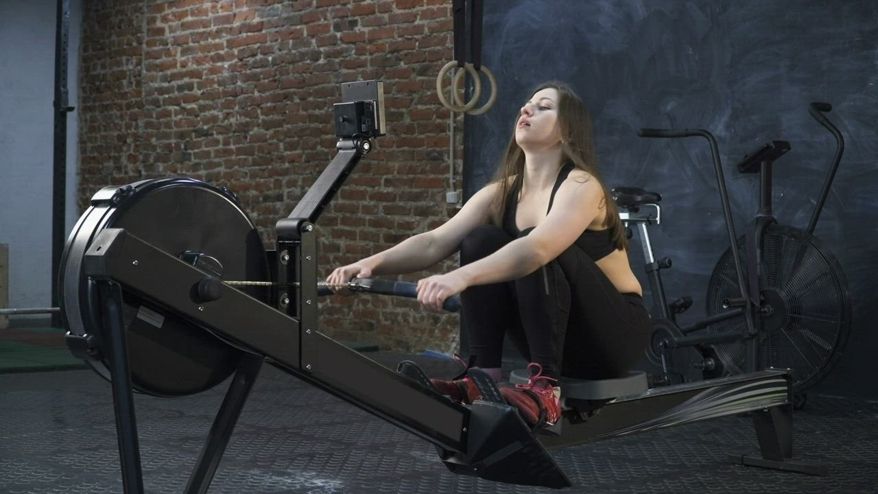 Woman using a rowing machine - Free Stock Video
