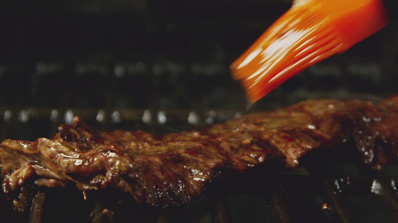 Basting a steak on the grill - Free Stock Video