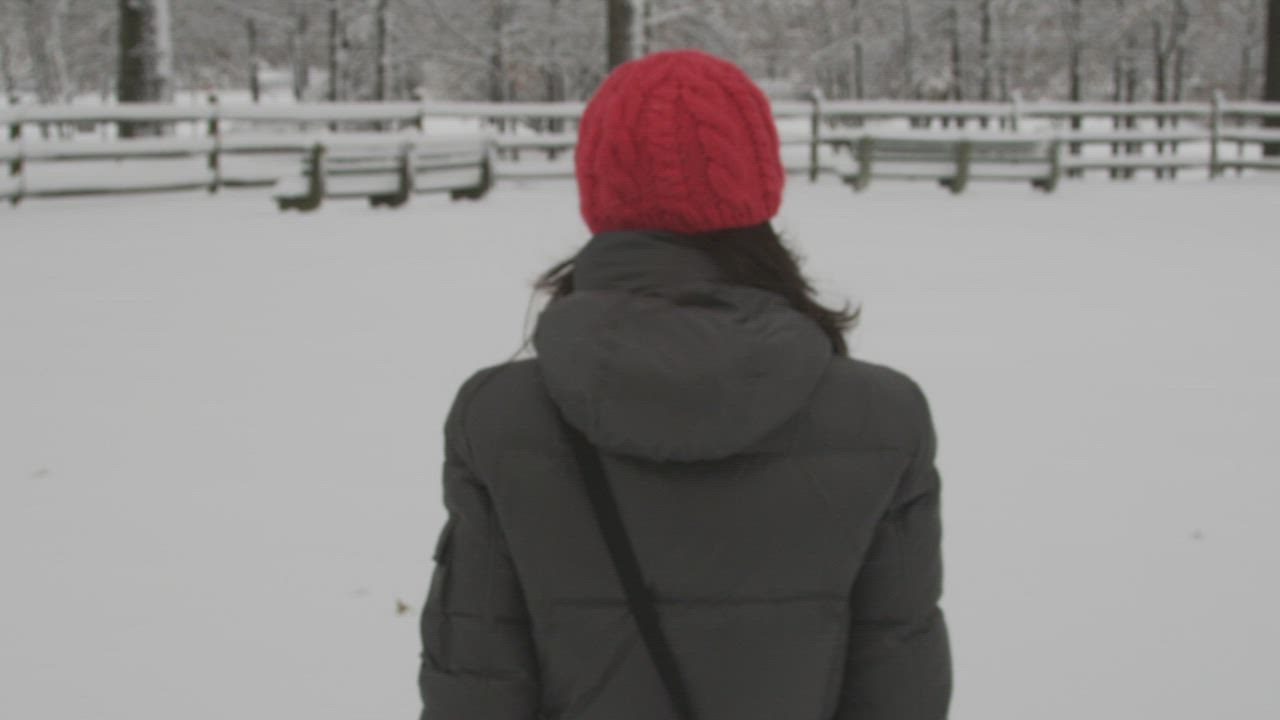 Woman walking slowly through snow - Free Stock Video