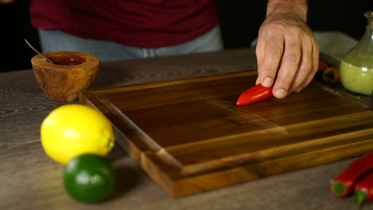Cutting up a chilli on a board - Free Stock Video
