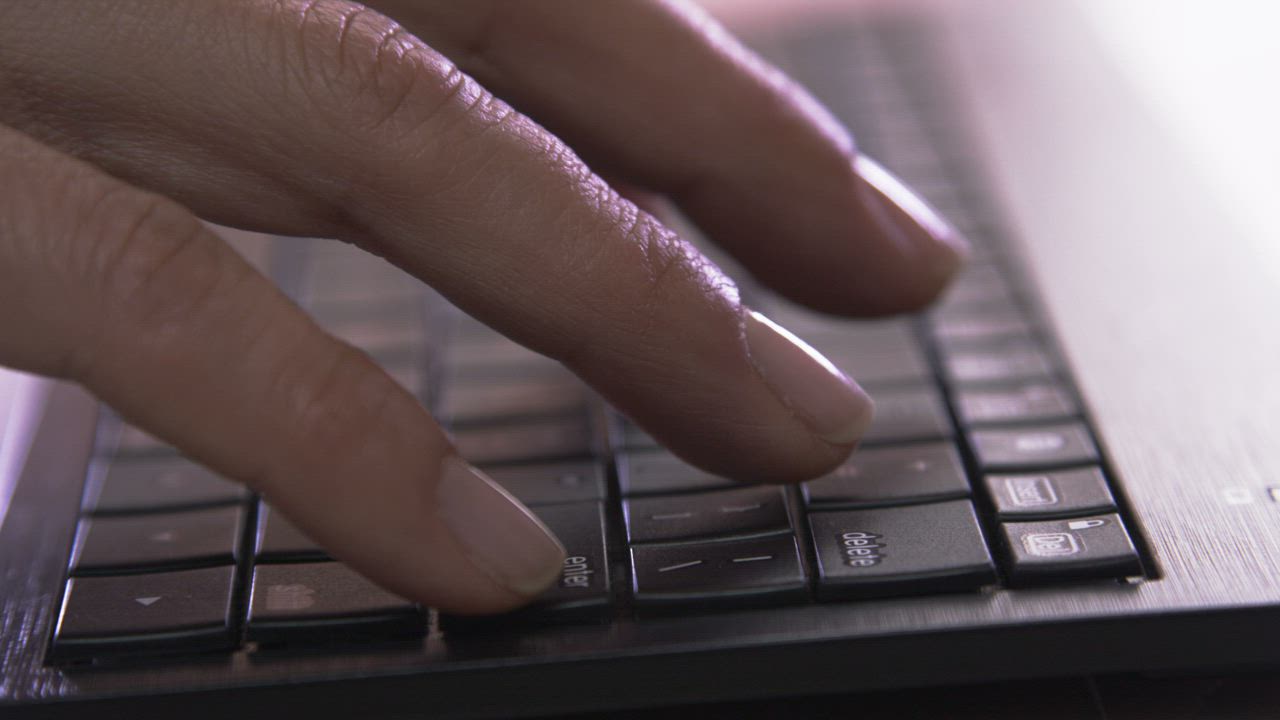 Hands typing on a flat keyboard - Free Stock Video