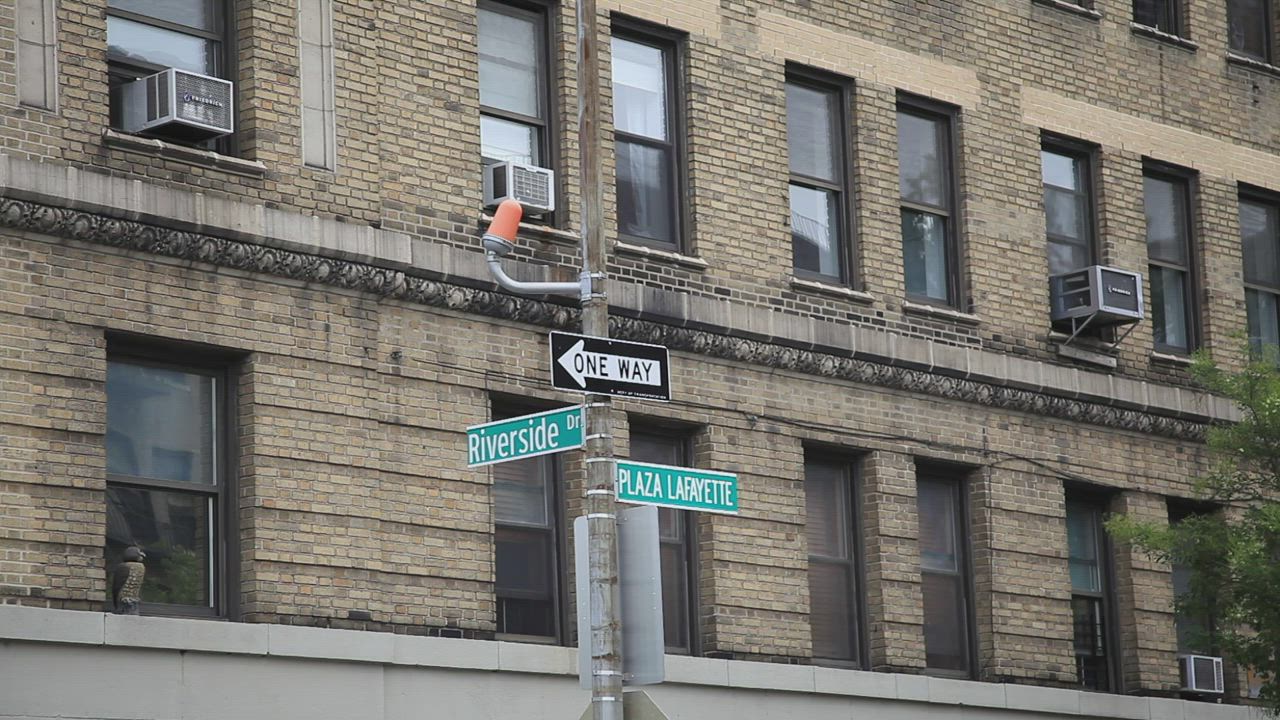 Street signs by a building - Free Stock Video