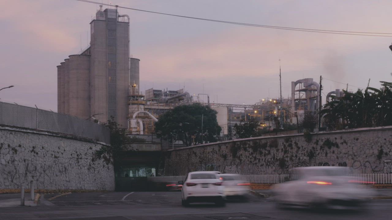City traffic near a factory at sunset, time-lapse - Free Stock Video